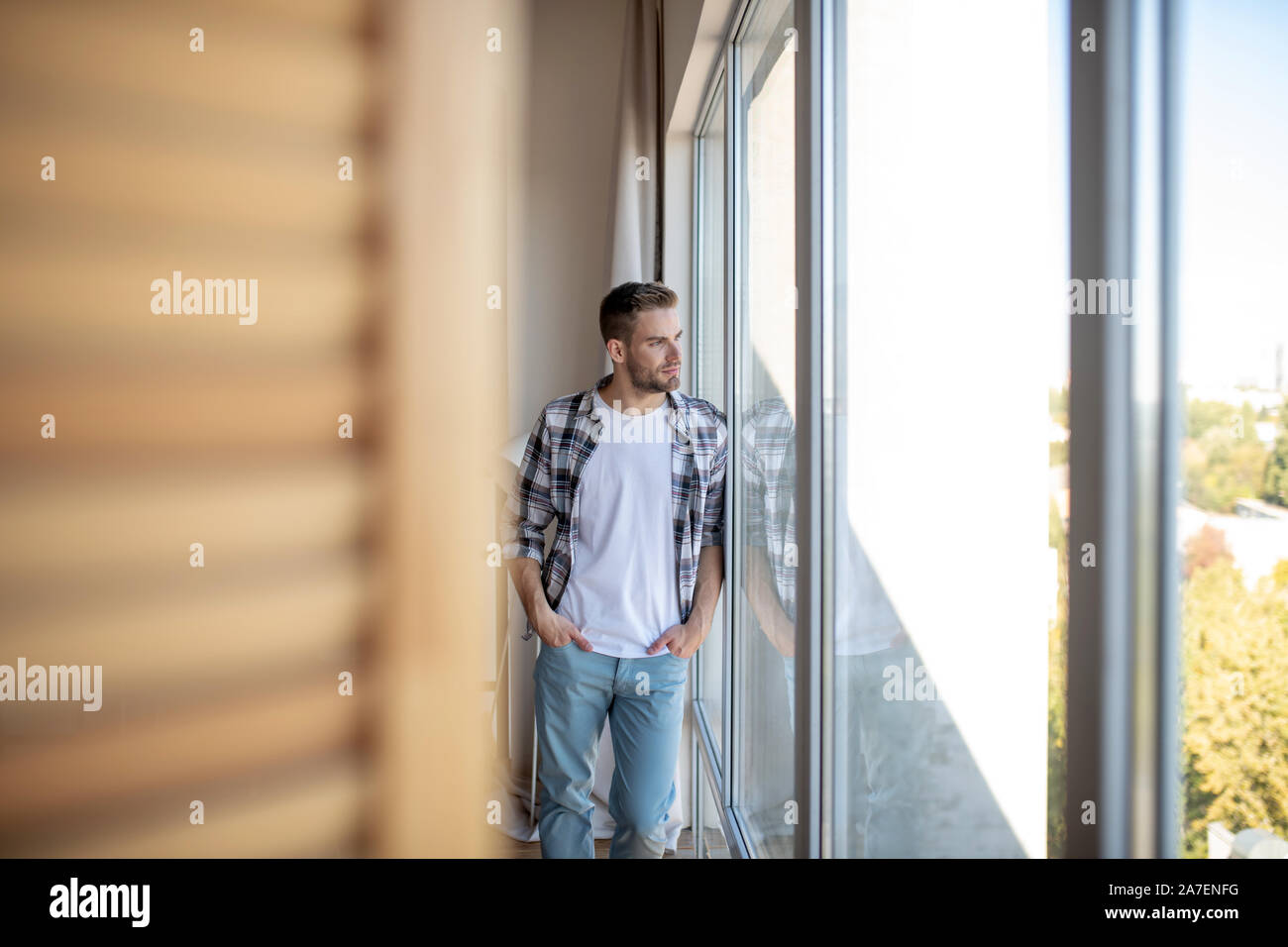 Person standing near window looking hi-res stock photography and images ...
