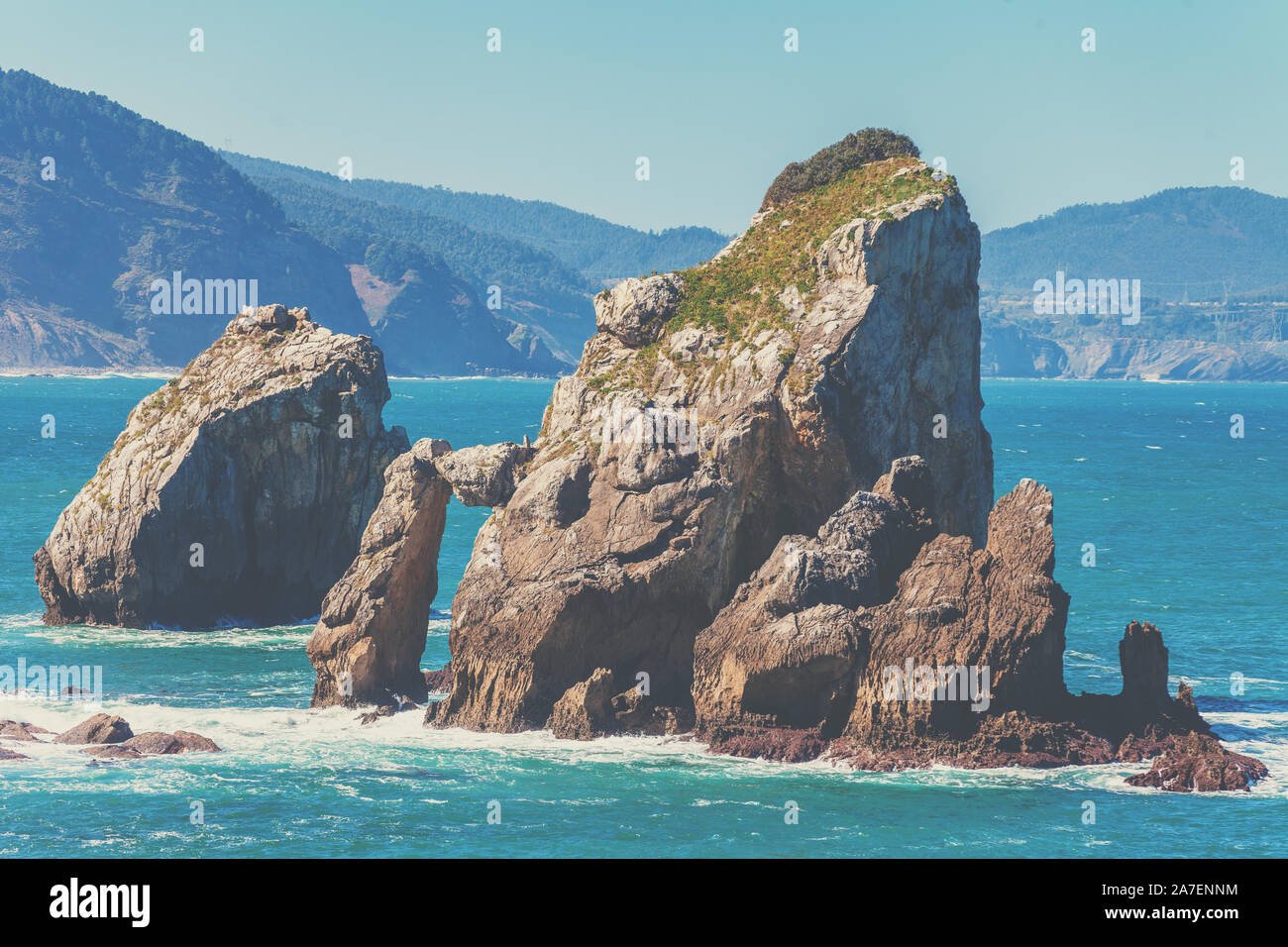 Rocky seashore near the island of Gaztelugatxe. Rock in the sea. Bay of ...