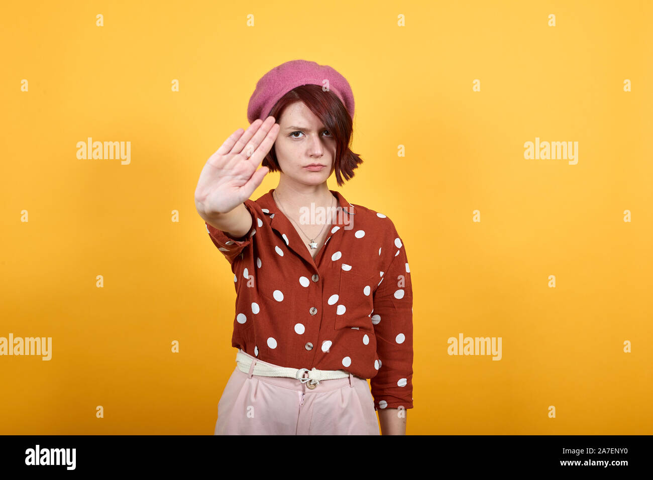 Gorgeous elegant lady doing stop sing with palm of the hand. Warning ...