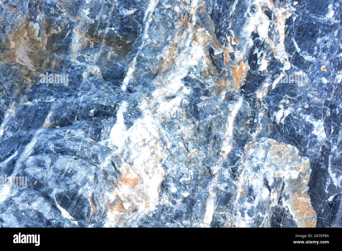 Natural granite rocks with veins of marble and minerals in intricate ...