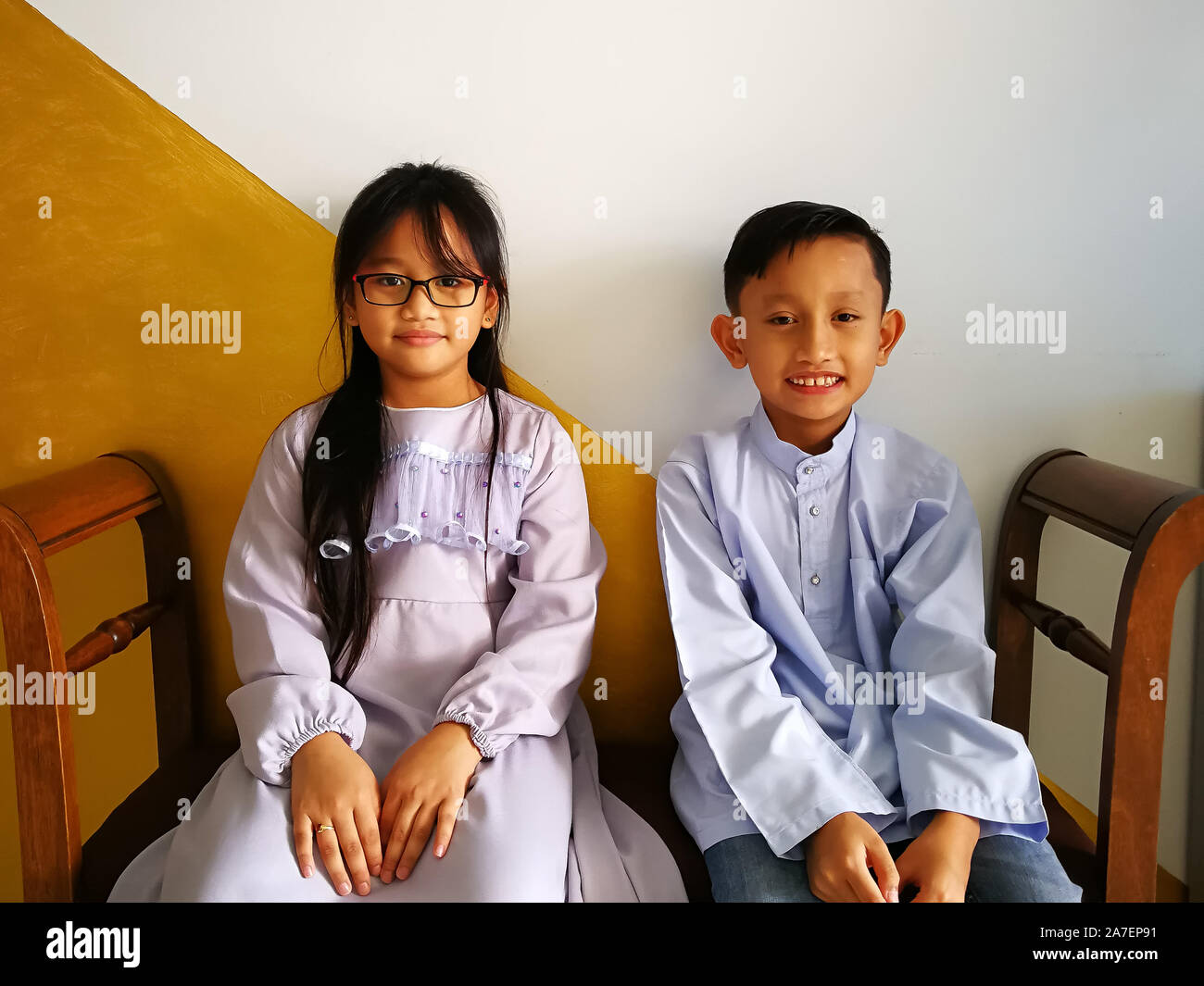 Asian muslim siblings sitting on the couch on Hari Raya eve Stock Photo ...