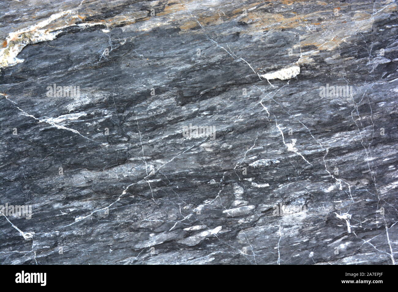 Natural granite rocks with veins of marble and minerals in intricate ...