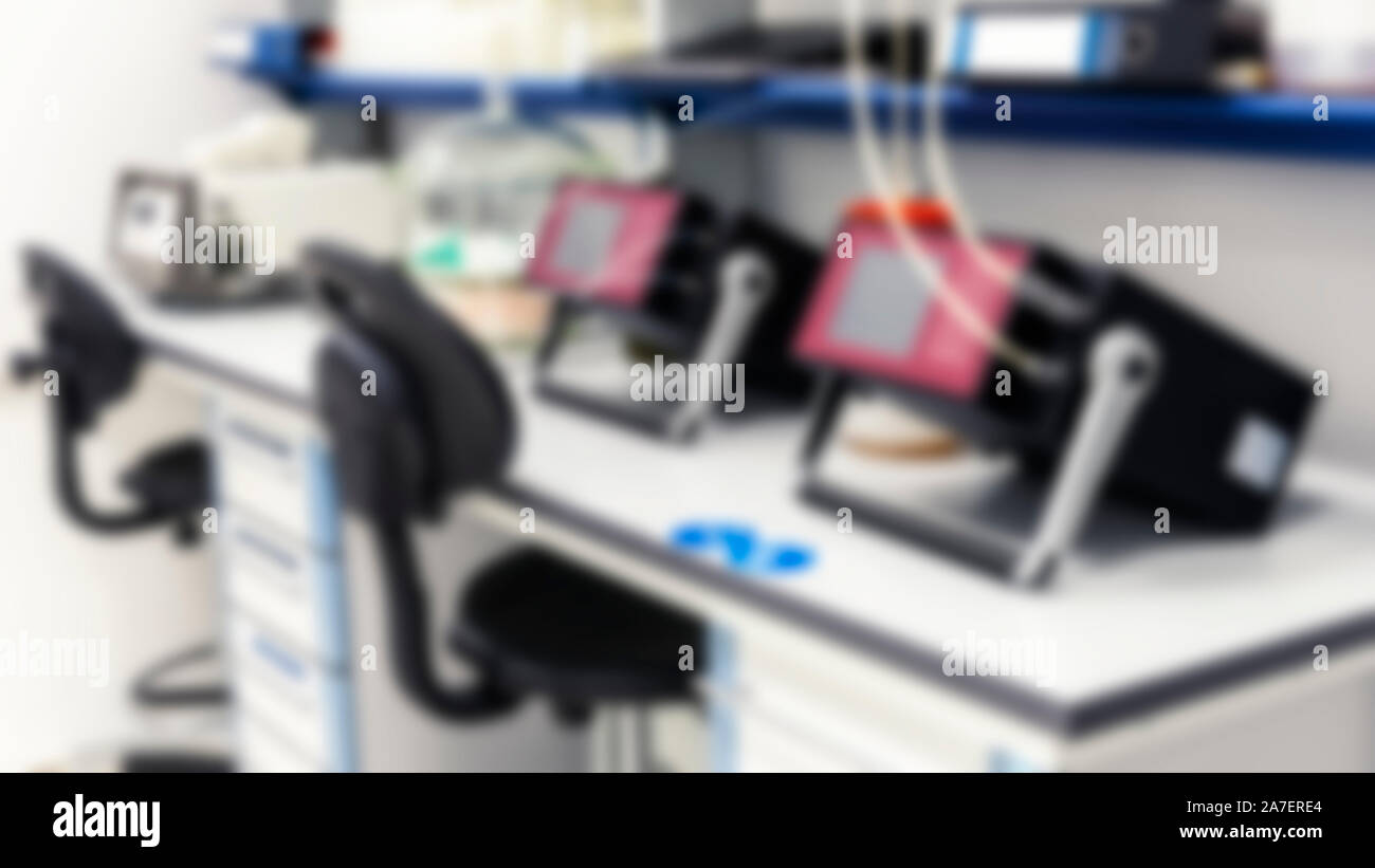 The background is blurry. Devices are on the tables in the test ...