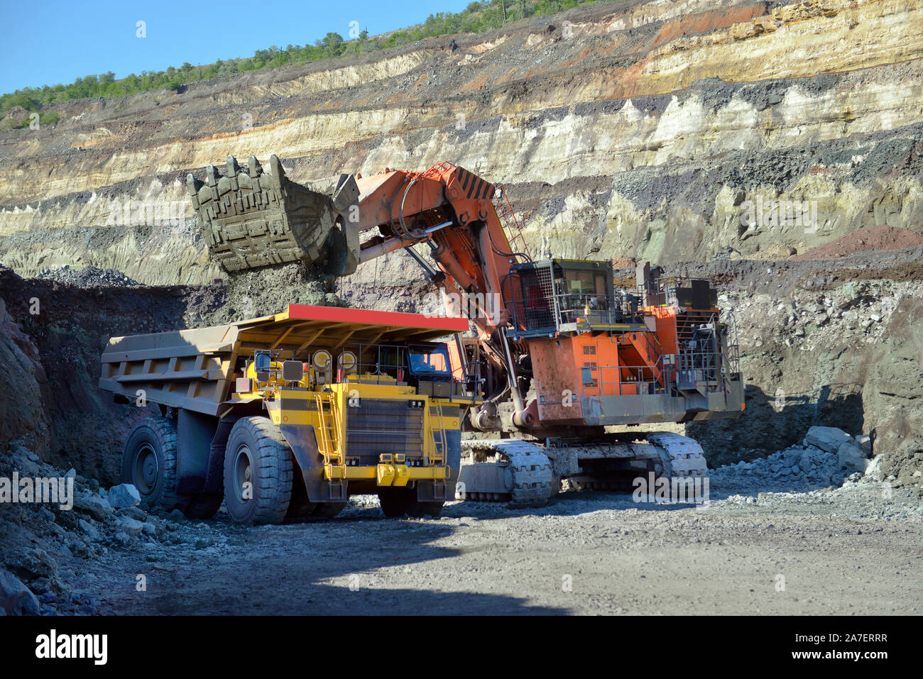 Large quarry dump truck. Loading the rock in the dumper. Loading coal into body work truck ...