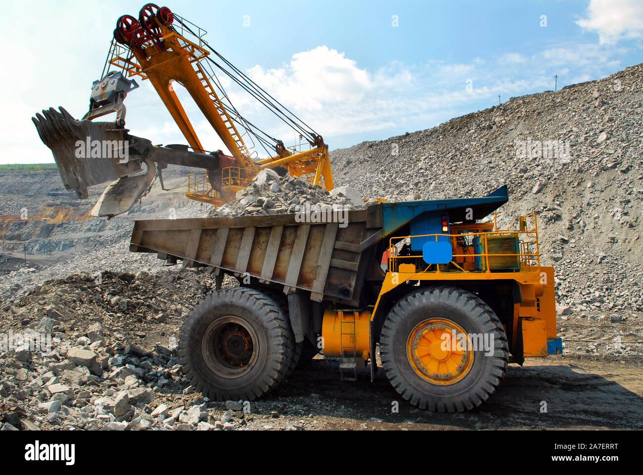 Large quarry dump truck. Loading the rock in the dumper. Loading coal into body work truck ...
