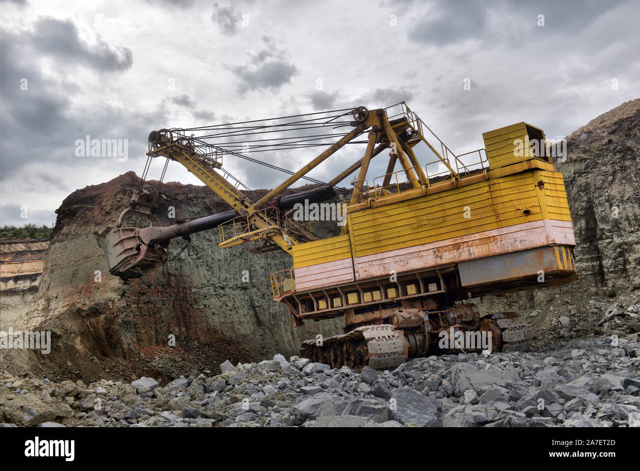 excavator works with granite or ore at opencast mining Stock Photo - Alamy