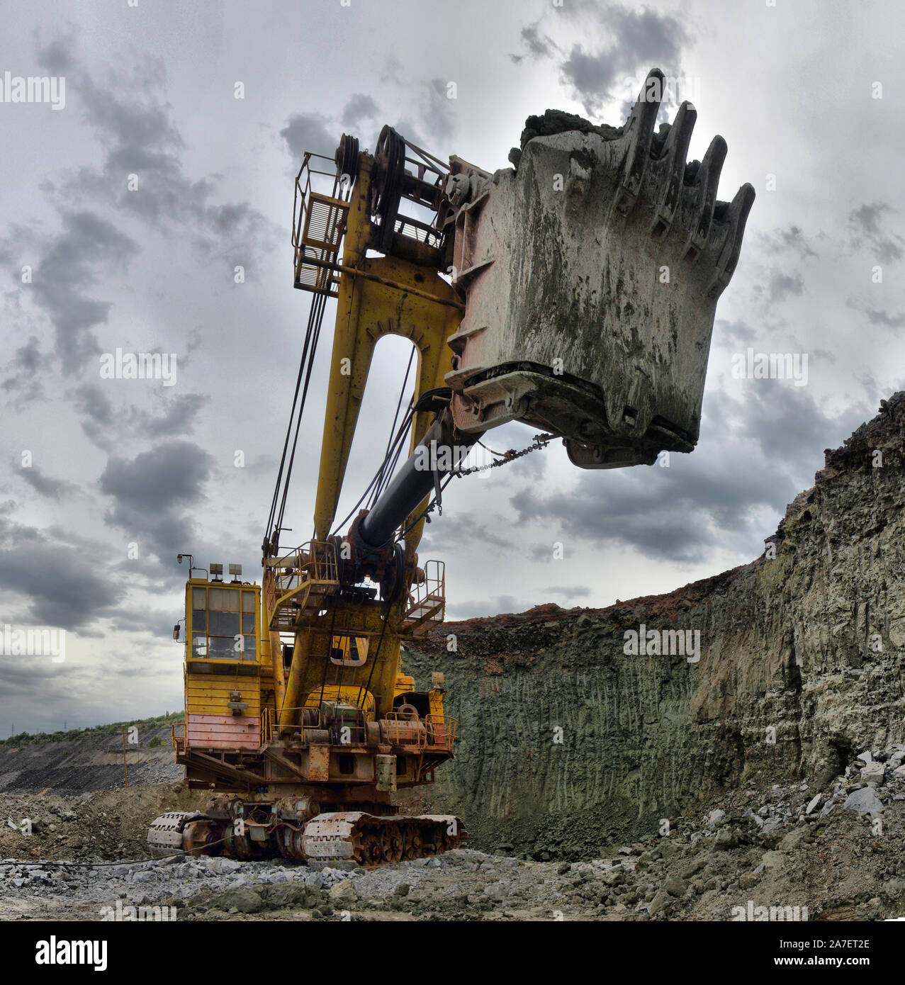 excavator works with granite or ore at opencast mining Stock Photo - Alamy