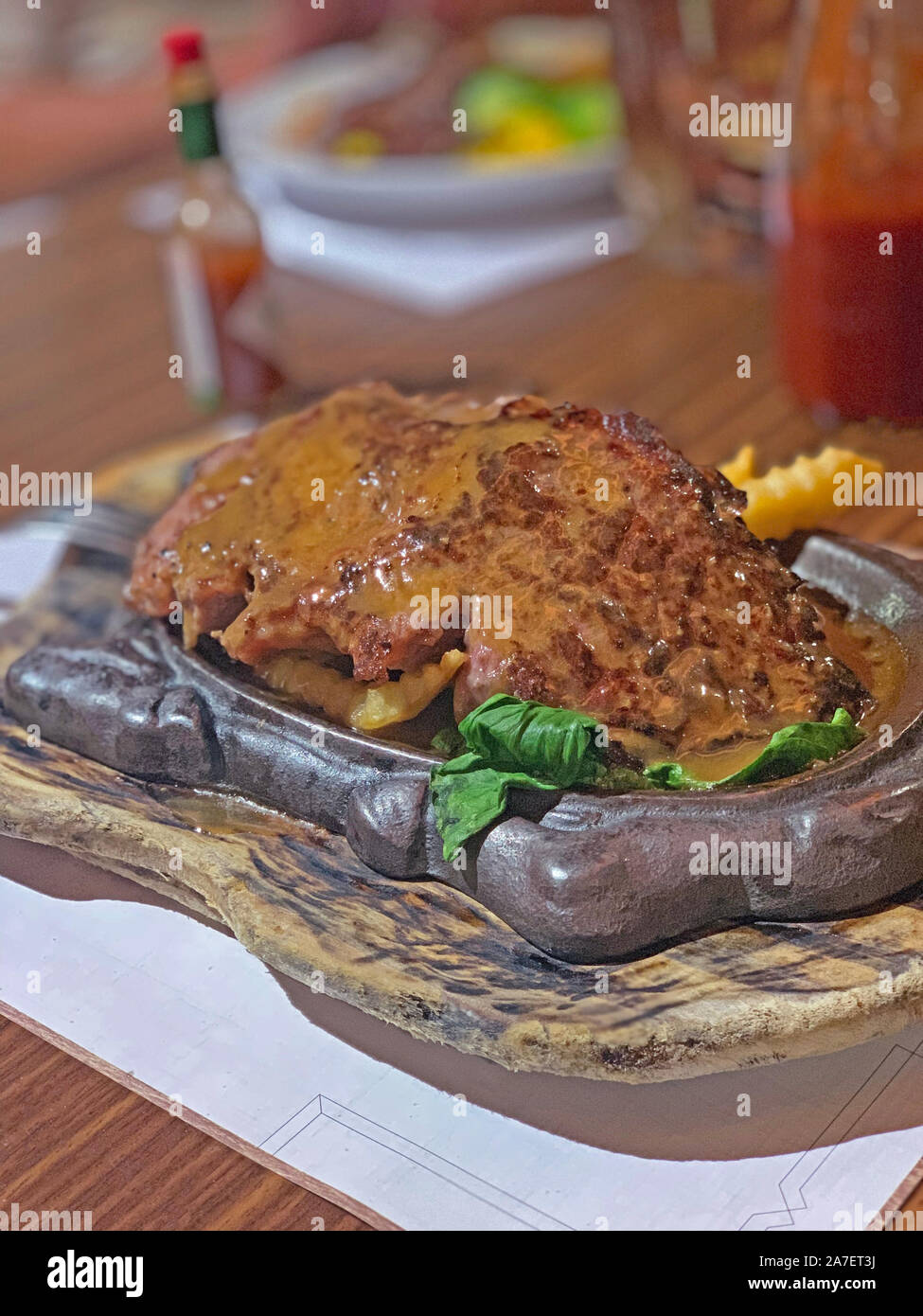 The vertical cooked steak meat with vegetable, french fries on the ...
