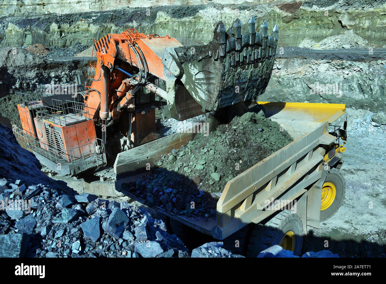 Large quarry dump truck. Loading the rock in the dumper. Loading coal ...