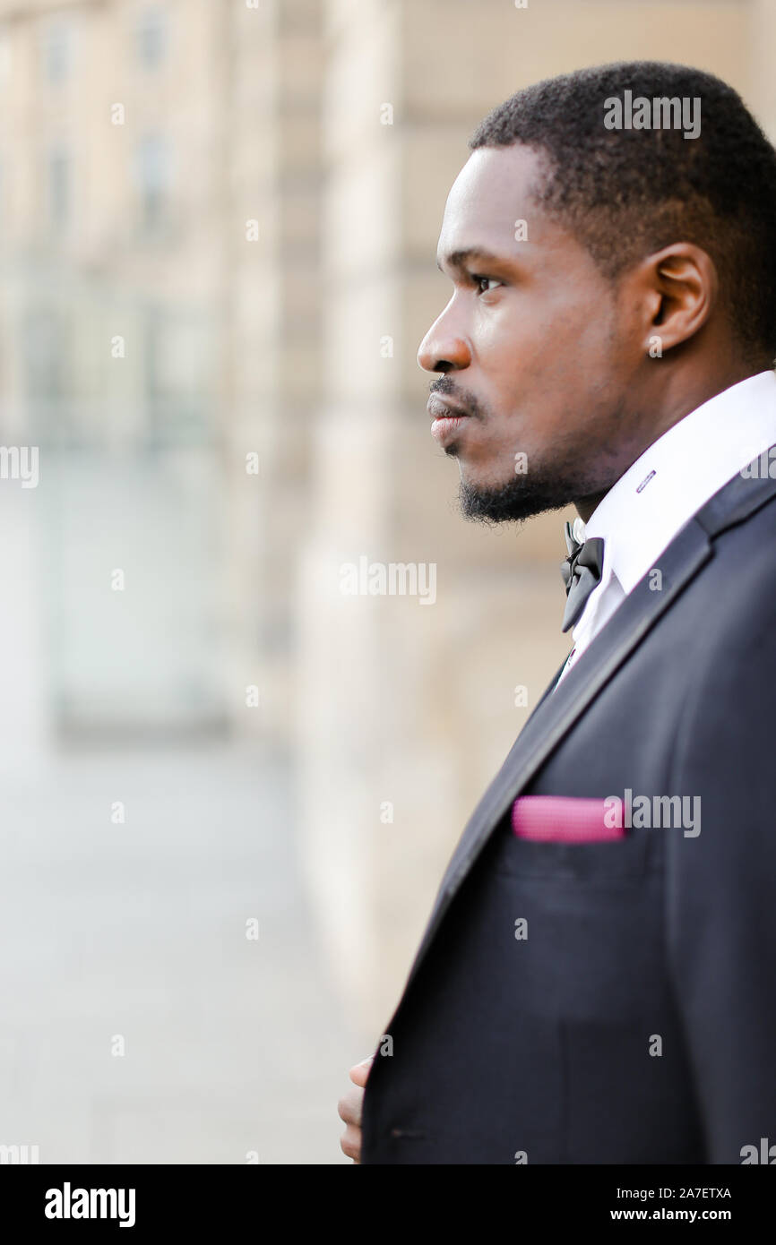 Portrait of afro american happy man wearing suit and standing near ...