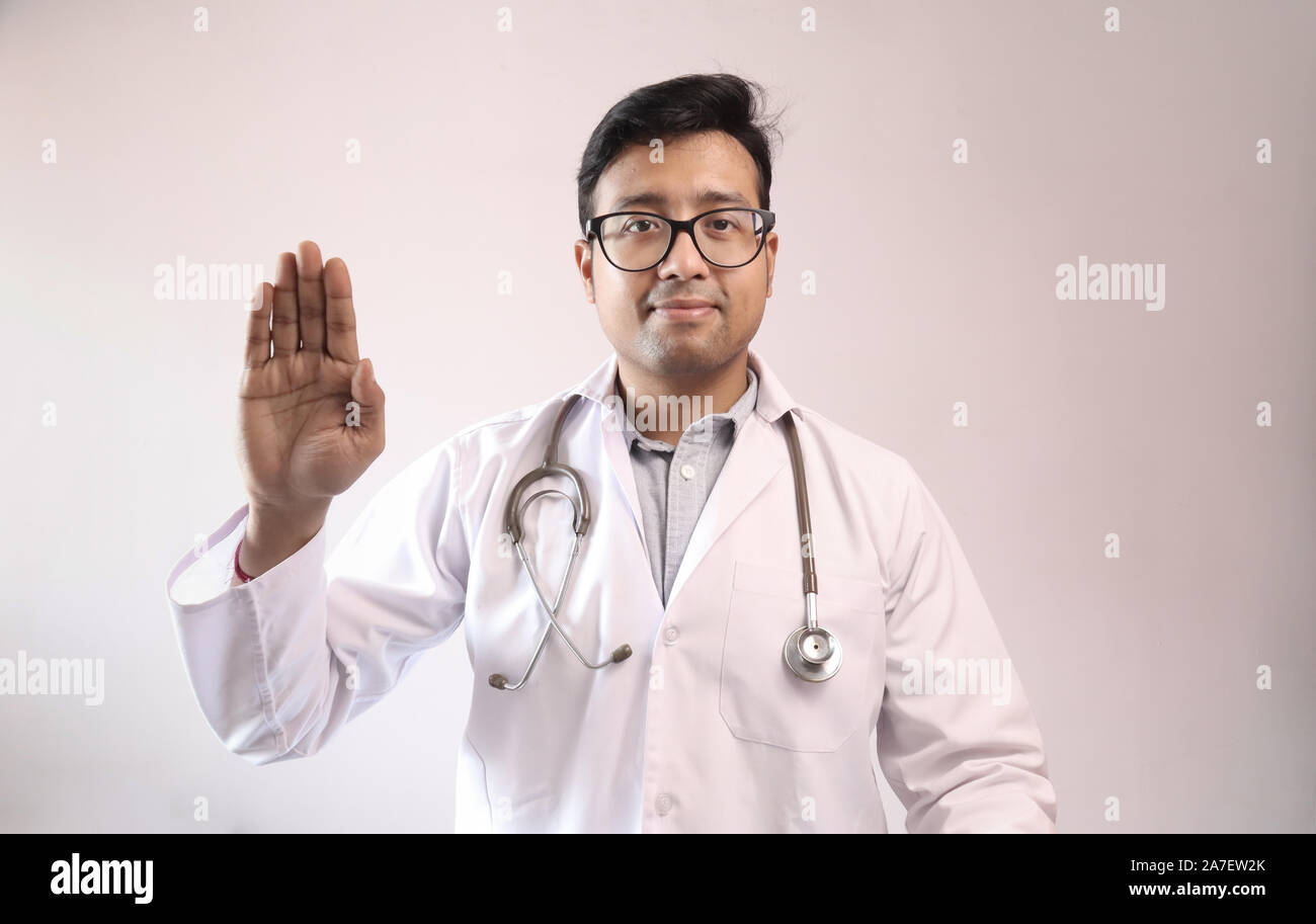 male indian doctor in white coat and stethoscope swearing hippocratic ...