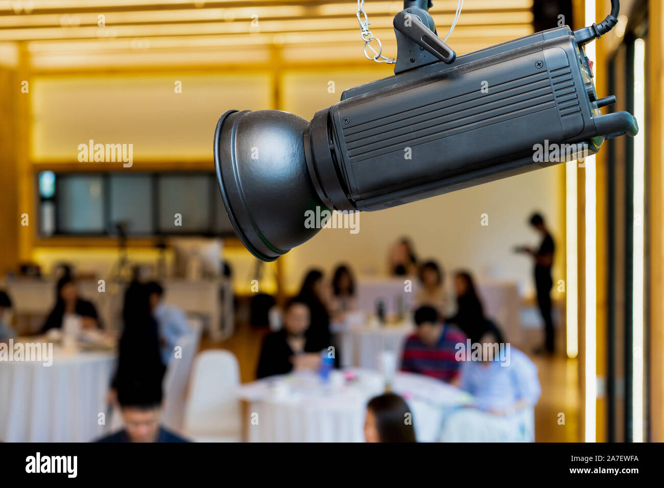 LED spotlight in the seminar classroom hall with blur people behind ...