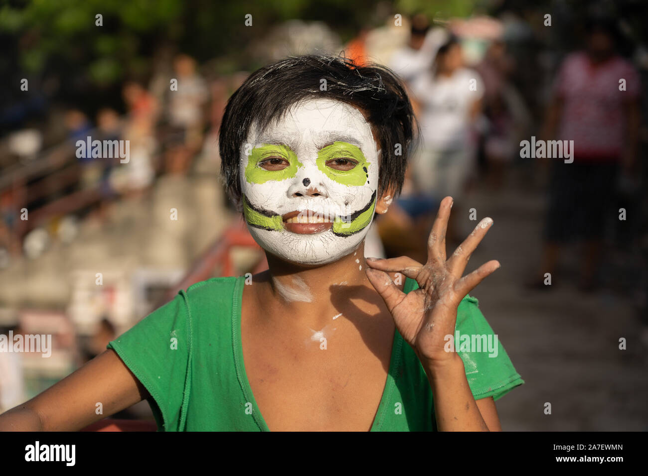 A young boy with a ghoulish painted face during the halloween,All ...