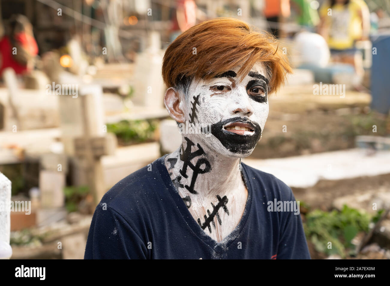 A young boy with a ghoulish painted face during the halloween,All ...