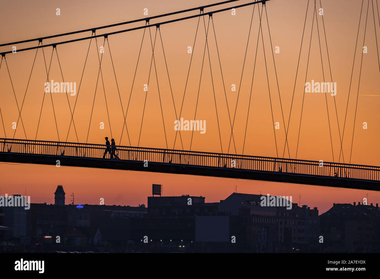Osijek bridge in sunset. Couple crossing bridge at sunset Stock Photo ...