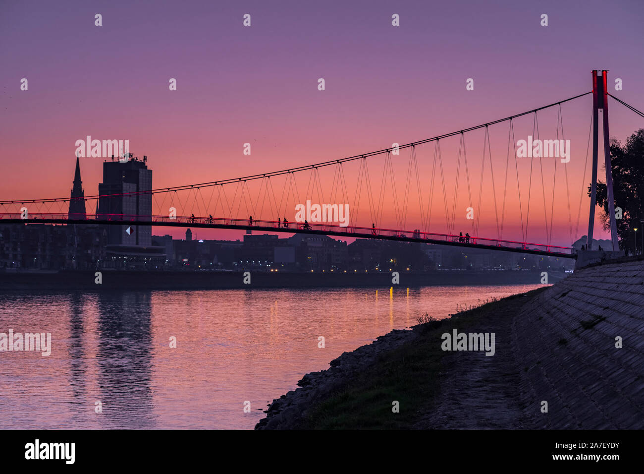 Osijek sunset, illuminated pedestrian bridge over river Drava Stock ...