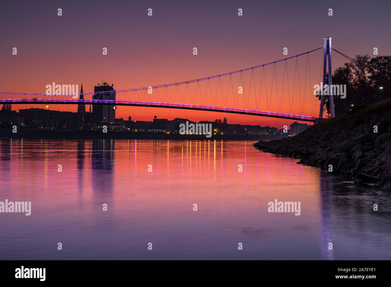 Osijek sunset panorama. Pedestrian bridge over Drava river at sunset ...
