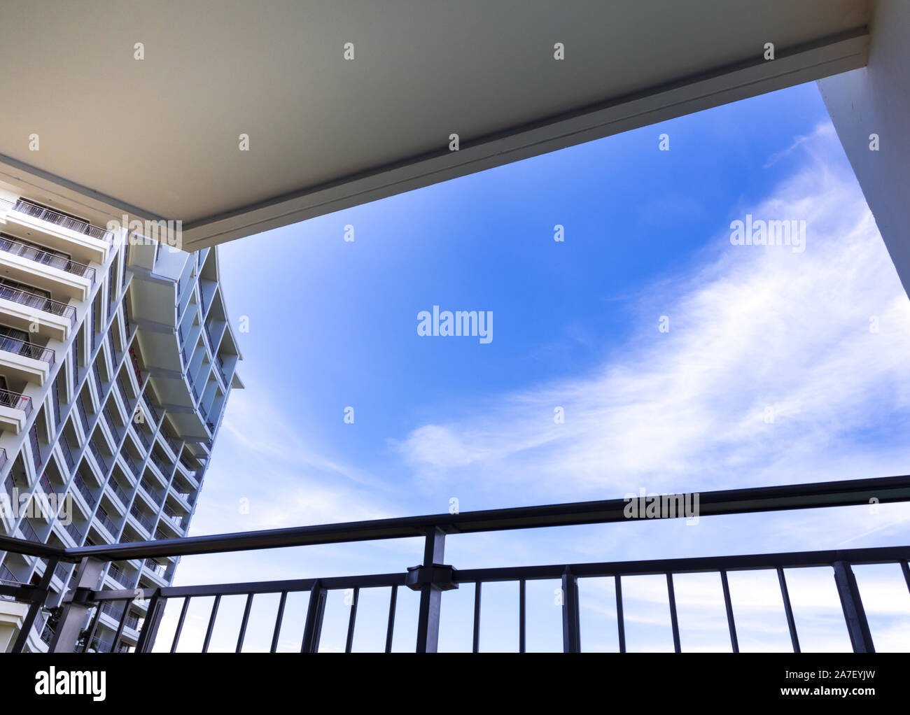 High-rise building and blue sky view from balcony Stock Photo - Alamy