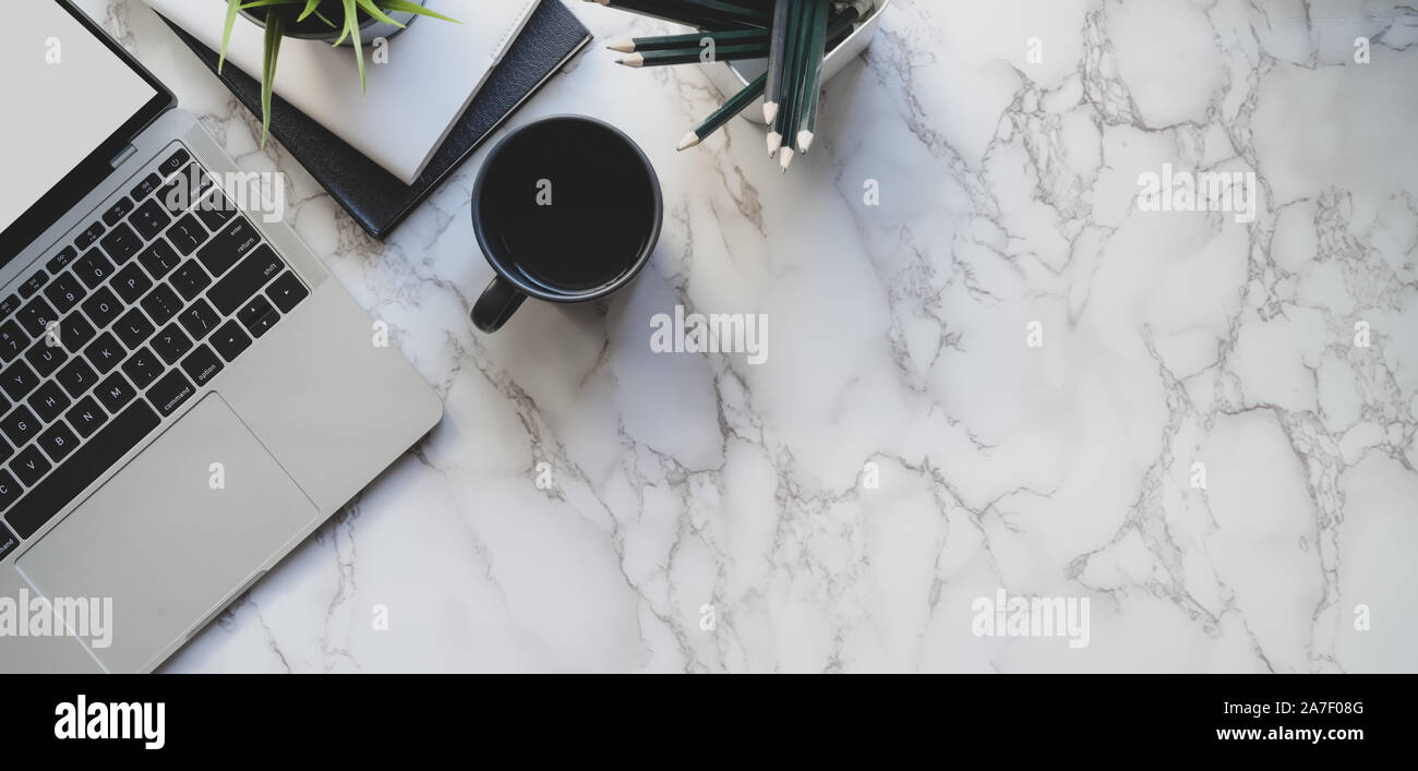 Top view of stylish workspace with laptop computer and office supplies ...