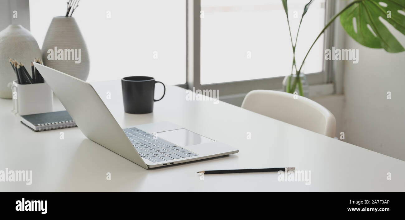 Comfortable office room with laptop computer and office supplies on ...