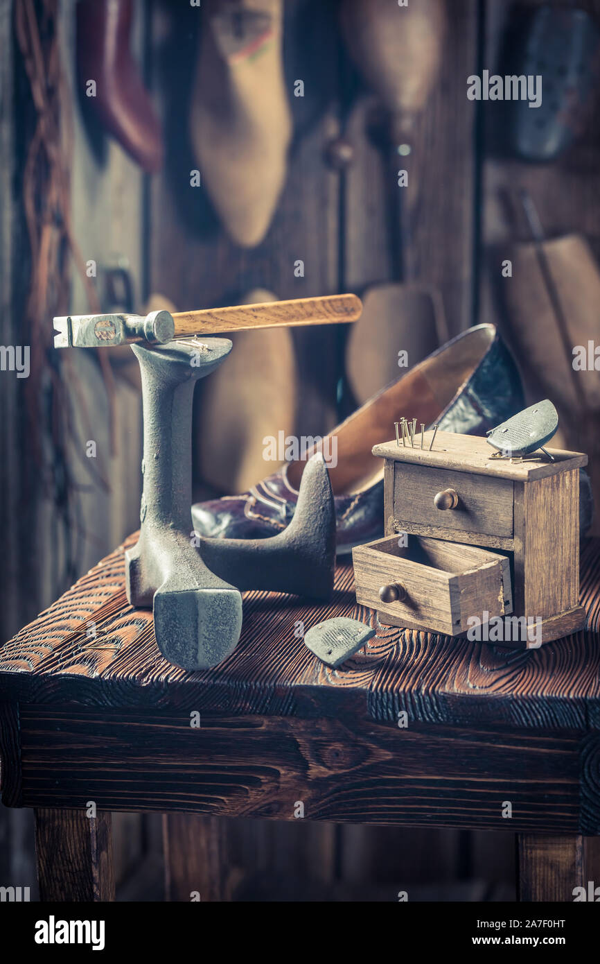 Rustic cobbler workshop with shoes and laces Stock Photo - Alamy