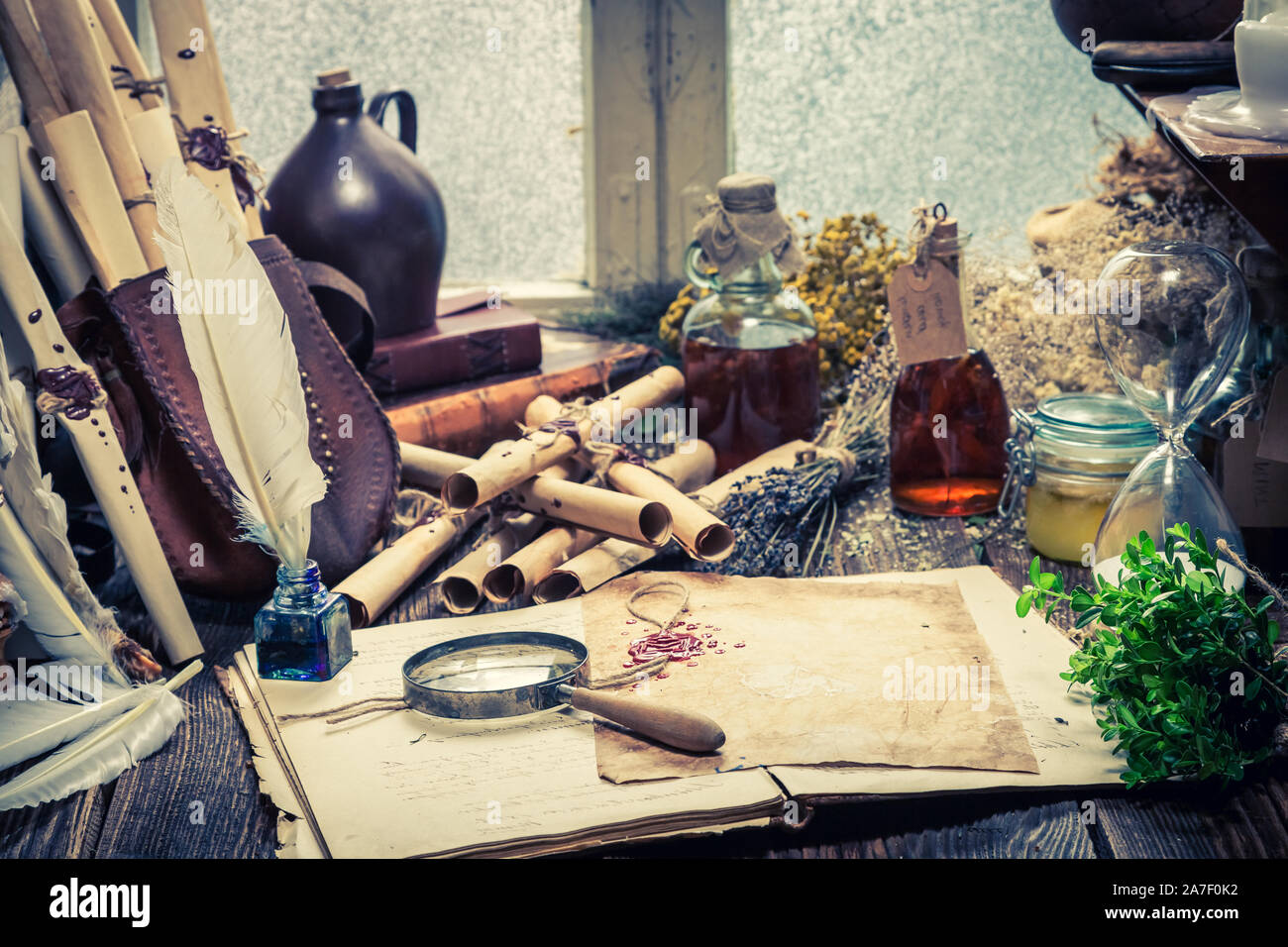Rustic witch workshop with old scrolls and plants Stock Photo - Alamy