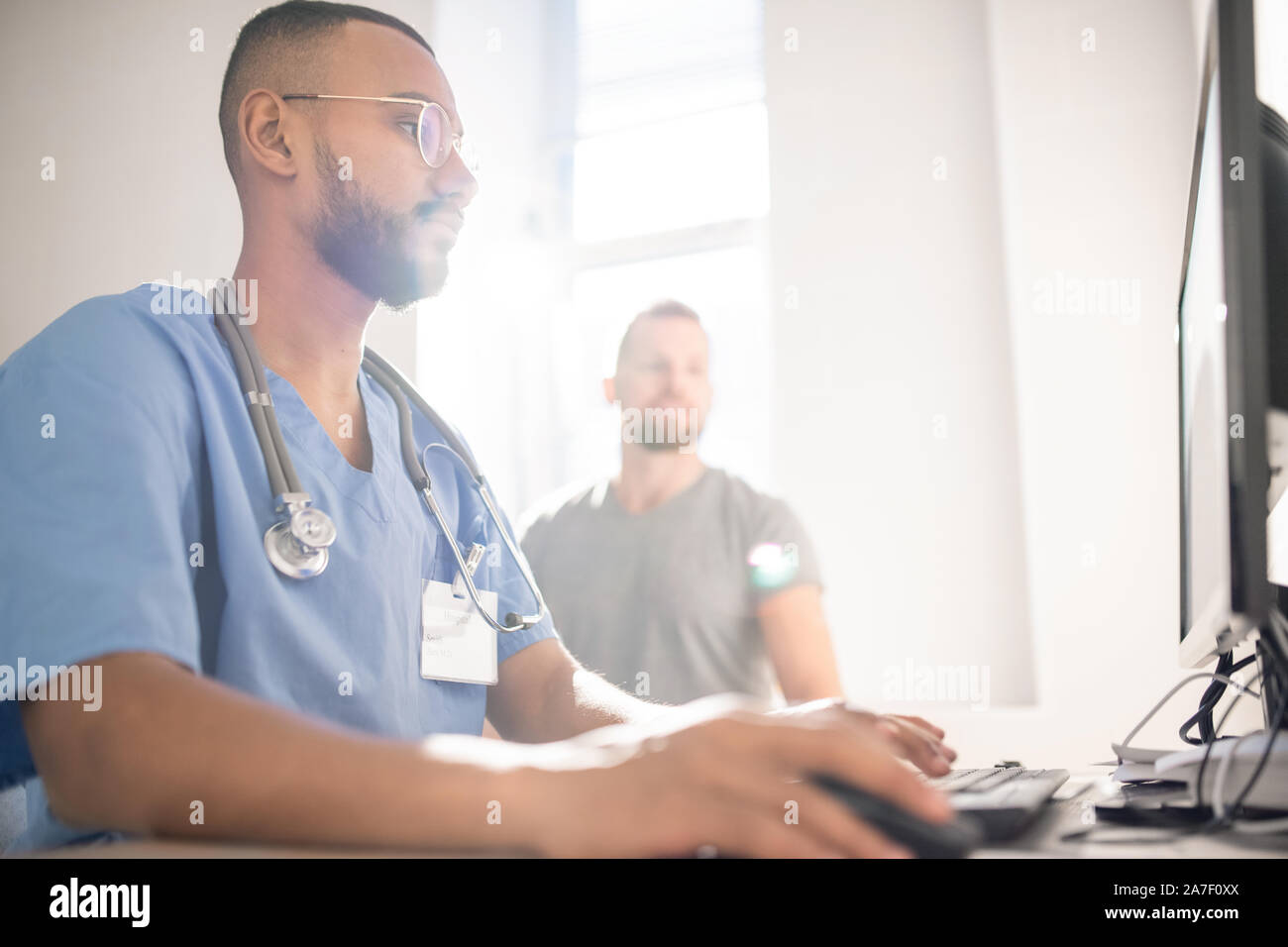Doctor nurse looking computer monitor hi-res stock photography and ...