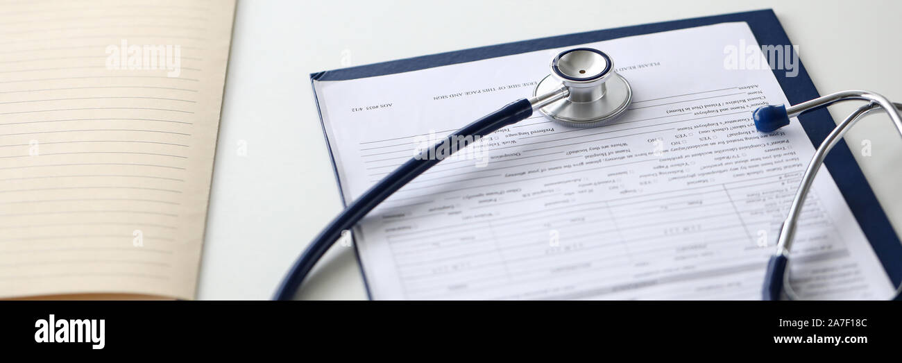 Stethoscope head lying on medical paper document Stock Photo - Alamy