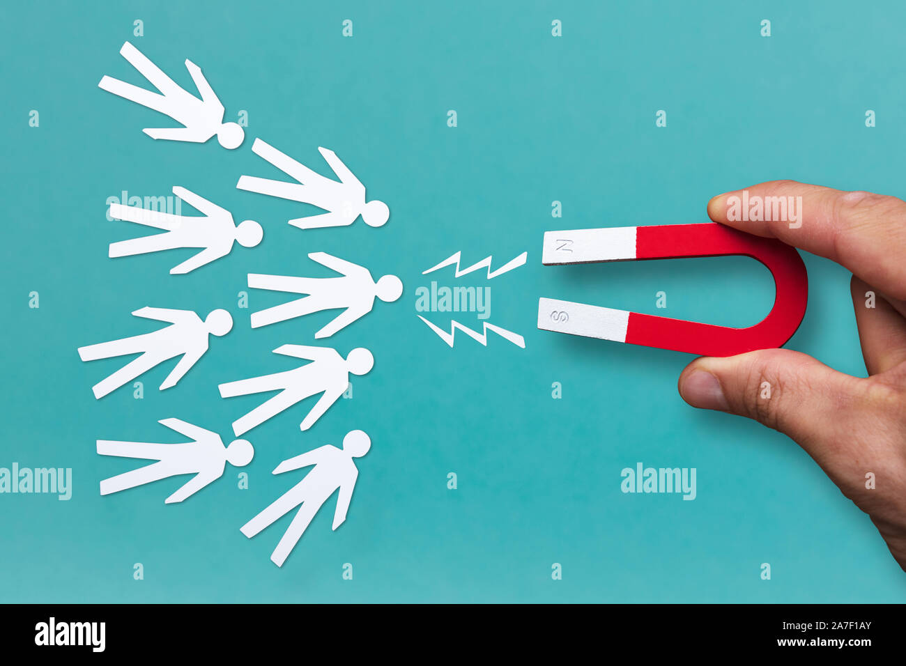 Close-up Of A Human Hand Attracting White Human Figures With Horseshoe ...