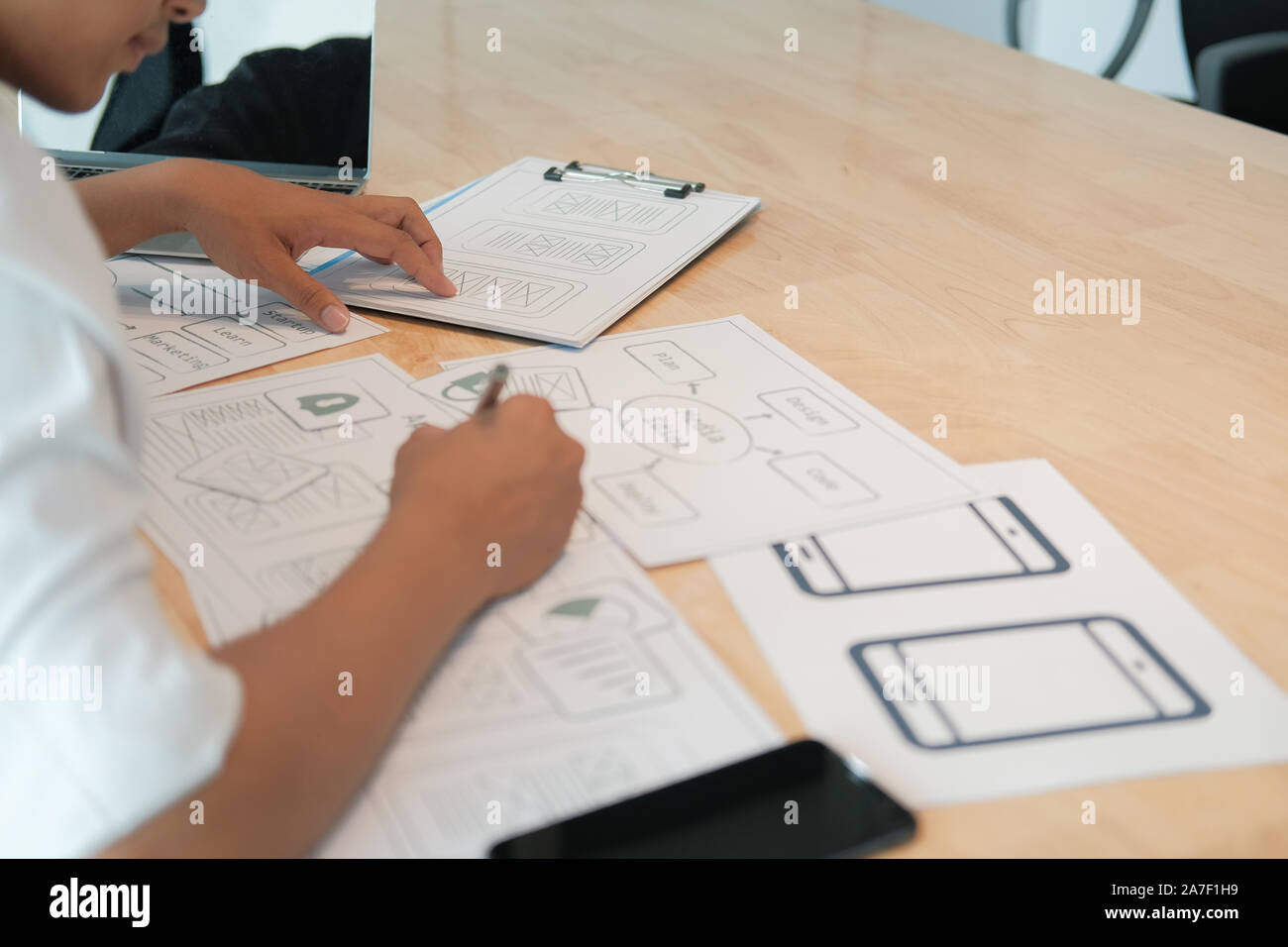 user experience UX designer designing web on smart phone layout. UI ...