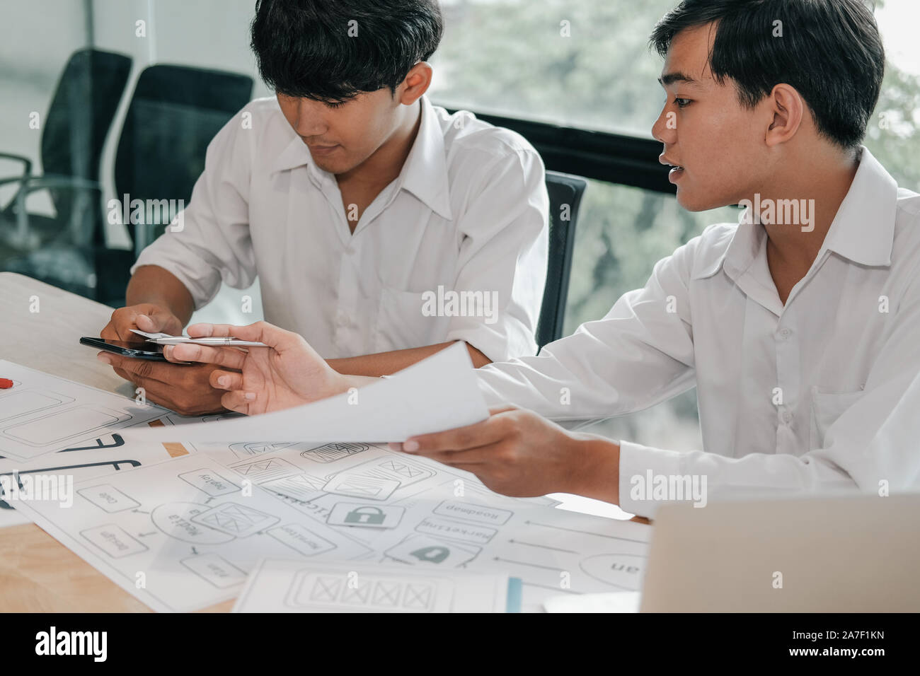 user experience UX designer designing web on smart phone layout. UI planning mobile application ...