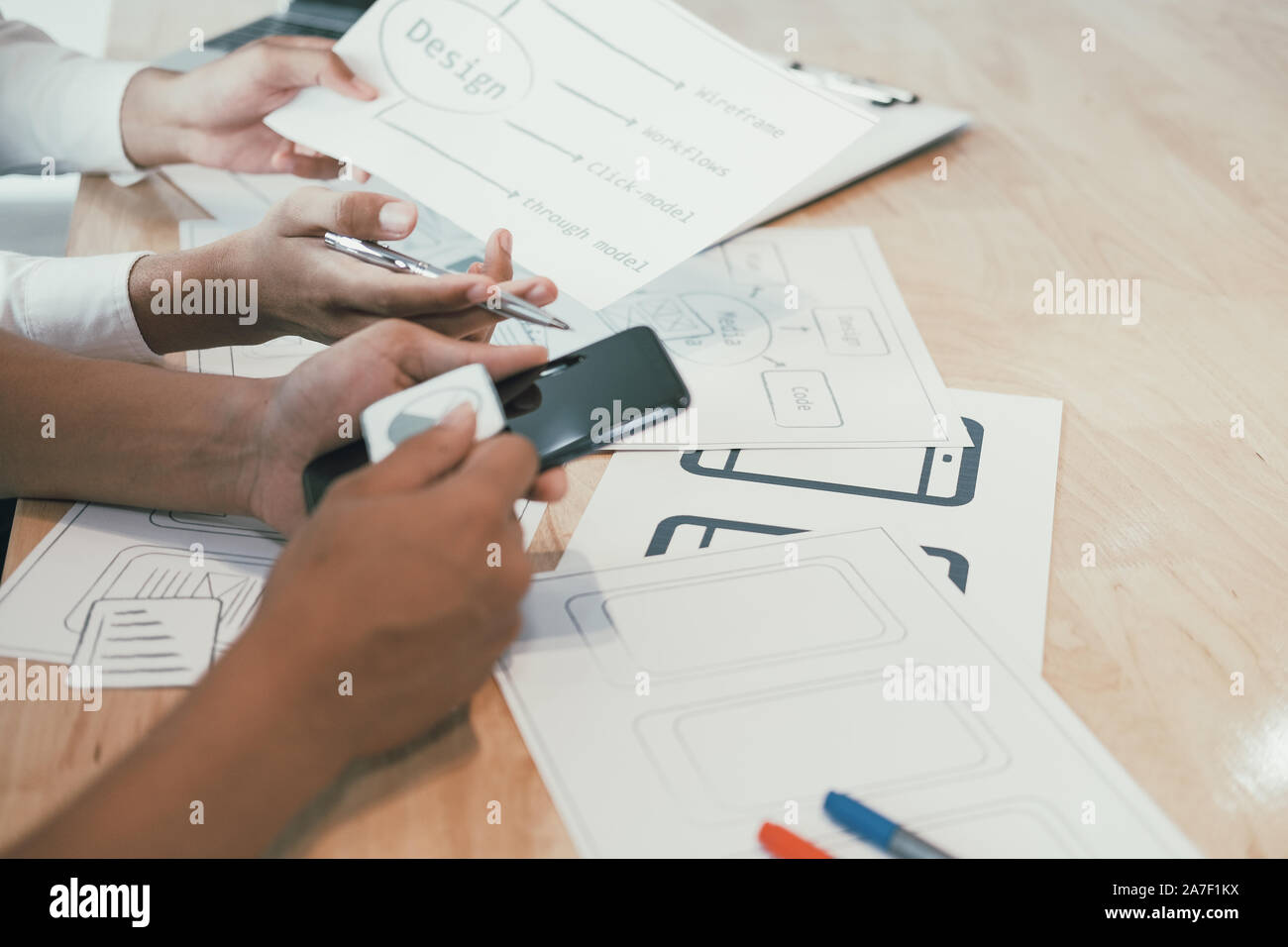 user experience UX designer designing web on smart phone layout. UI ...