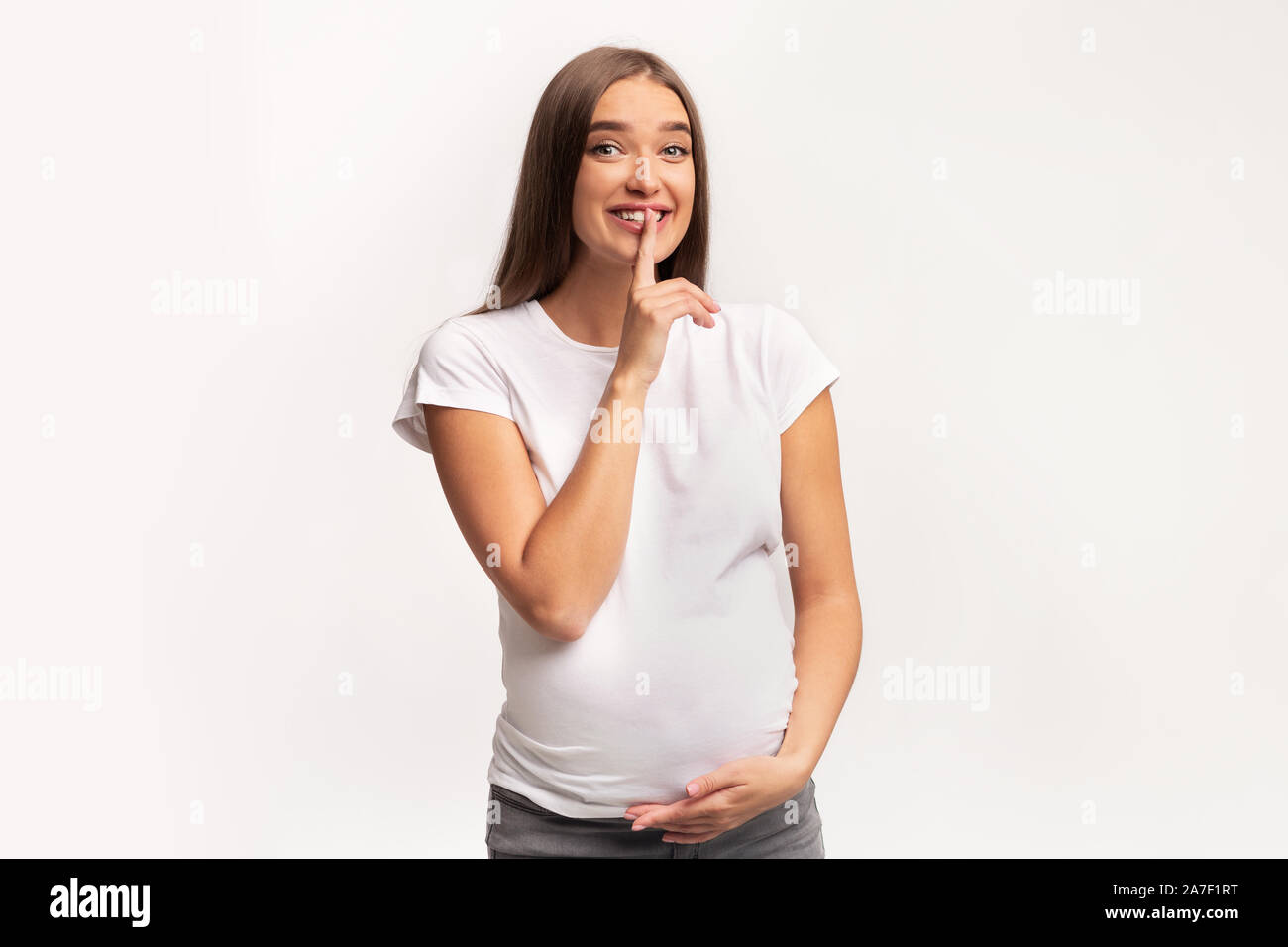 Pregnant Lady Gesturing Hush Sign Standing On White Studio Background ...
