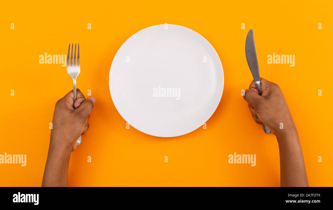 Top view of black female impatiently waiting for food Stock Photo - Alamy