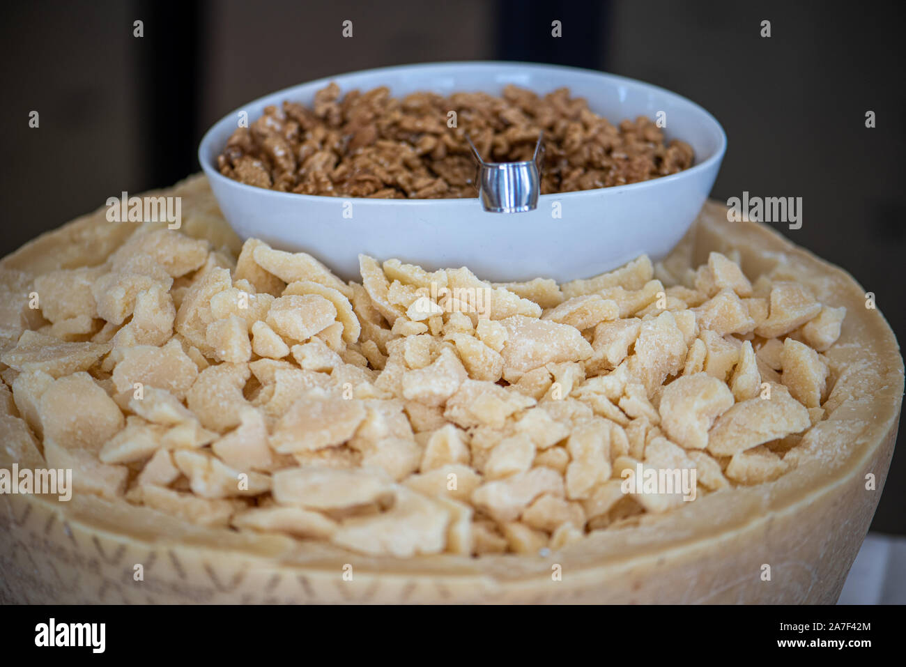 typical Italian cheese wheel containing pieces of cheese and a bowl of ...