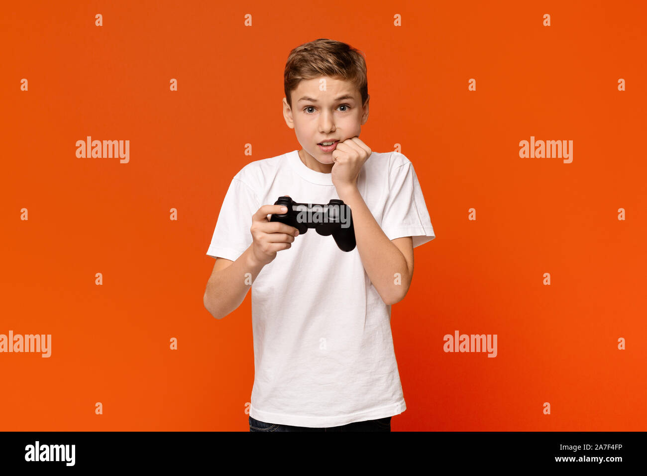 Nervous teen boy with joystick playing video games Stock Photo - Alamy