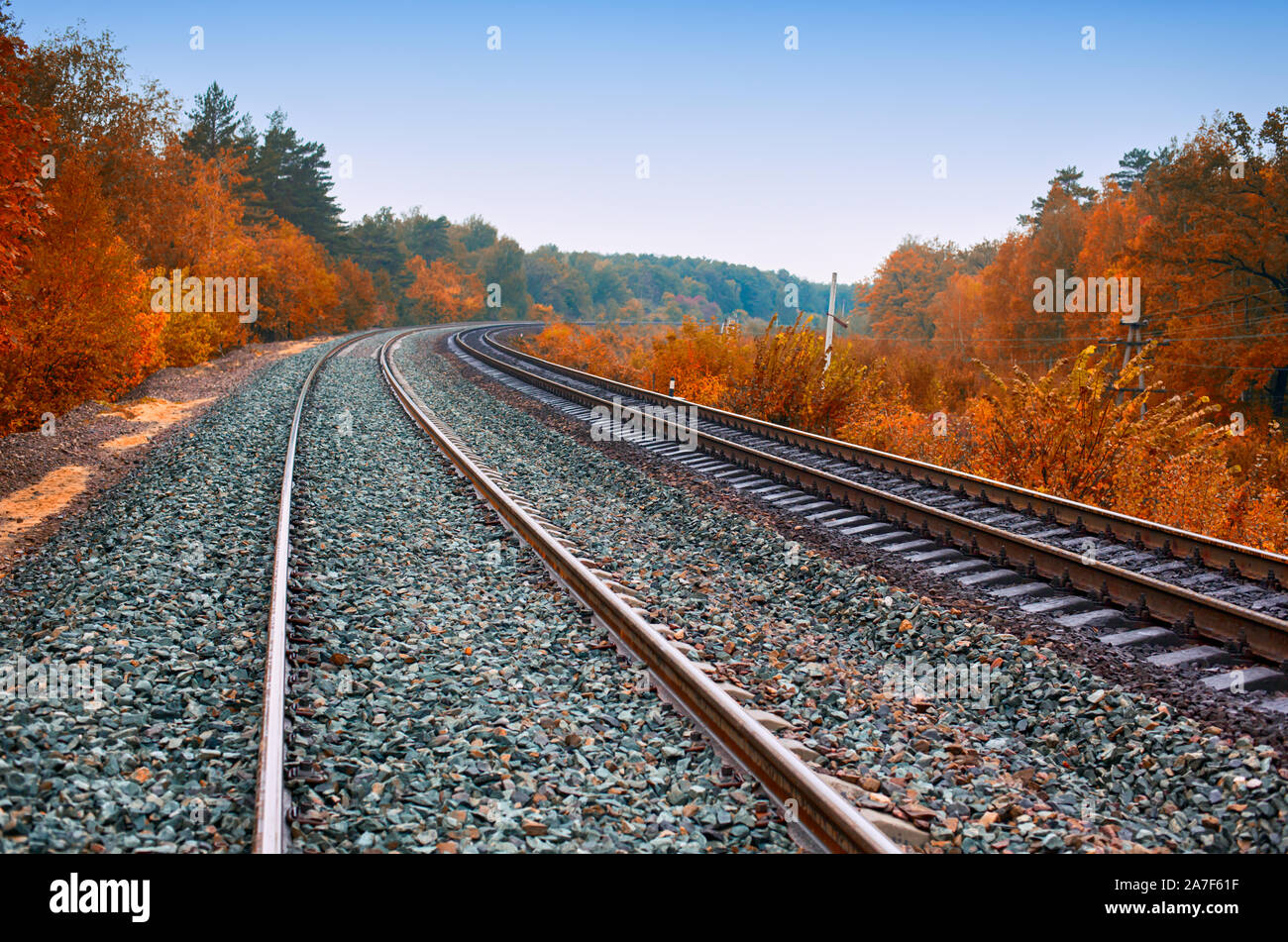 Train tracks view with autumn forest. Full frame Stock Photo - Alamy
