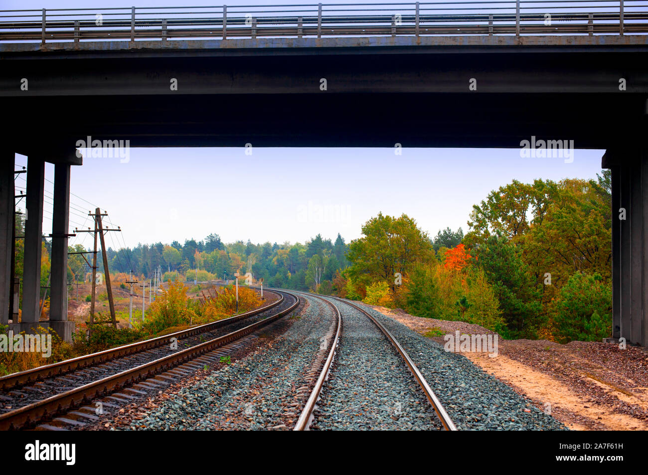 Train tracks under the bridge. Autumn time. Full frame Stock Photo - Alamy