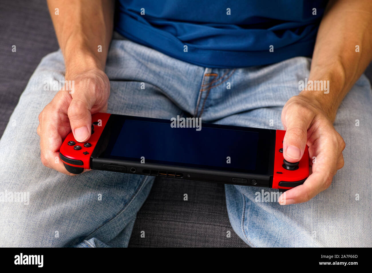 Tambov, Russian Federation - June 22, 2019 Man sitting on sofa and ...