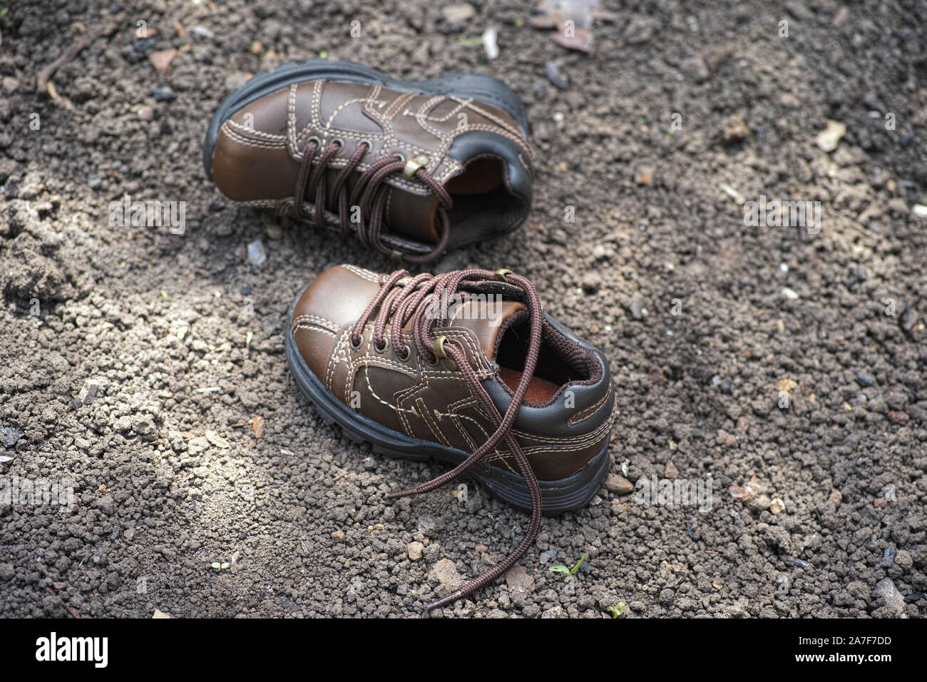 A pair of lost shoes. Missing kid or lost child concept Stock Photo - Alamy