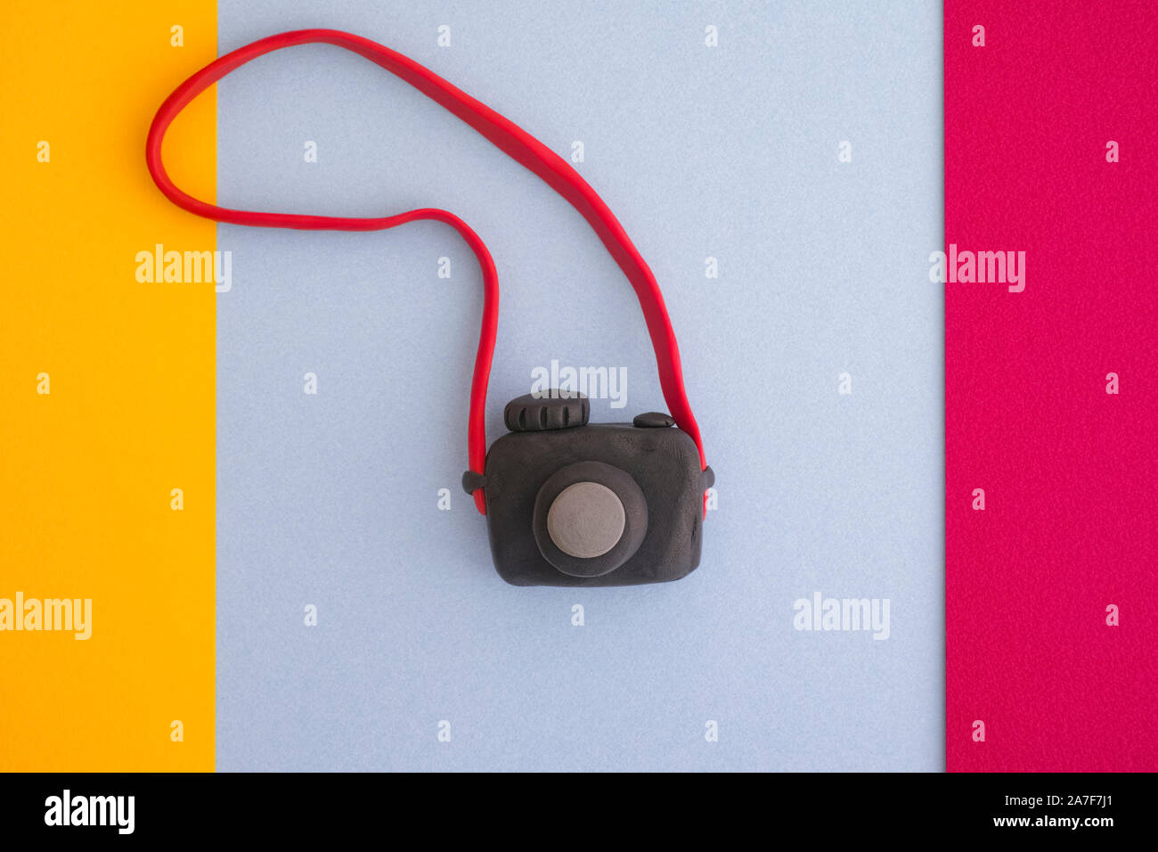 Black digital camera on a colorful background. Camera is made out of ...