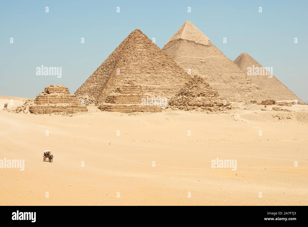 Horse drawn carts near Giza pyramids. Khufu, Khafre, Menkaure and ...