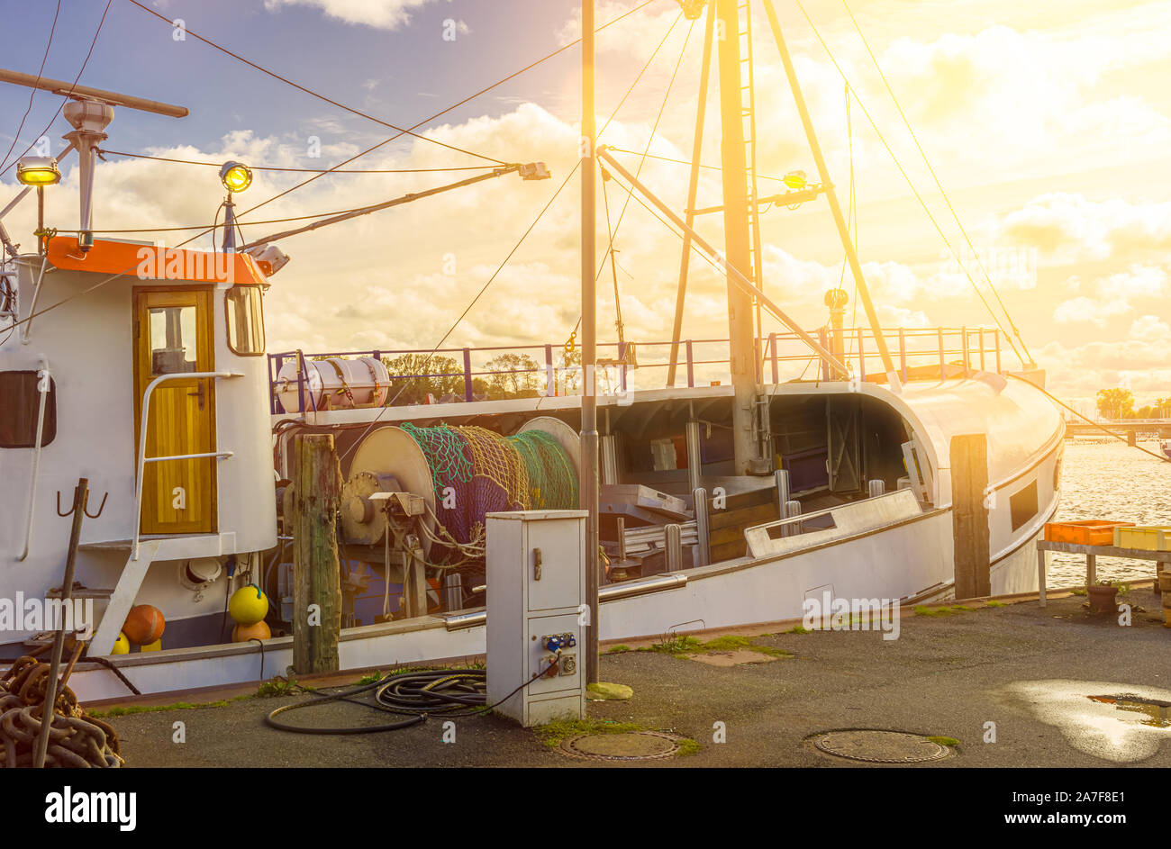 Fishing boat in port with backlit nets Fishing overfishing Stock Photo ...