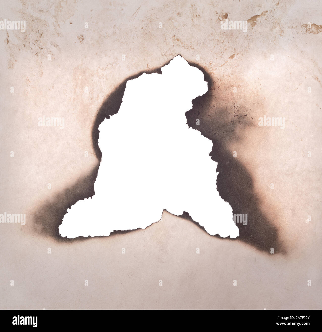 Burnt hole in a paper Stock Photo - Alamy