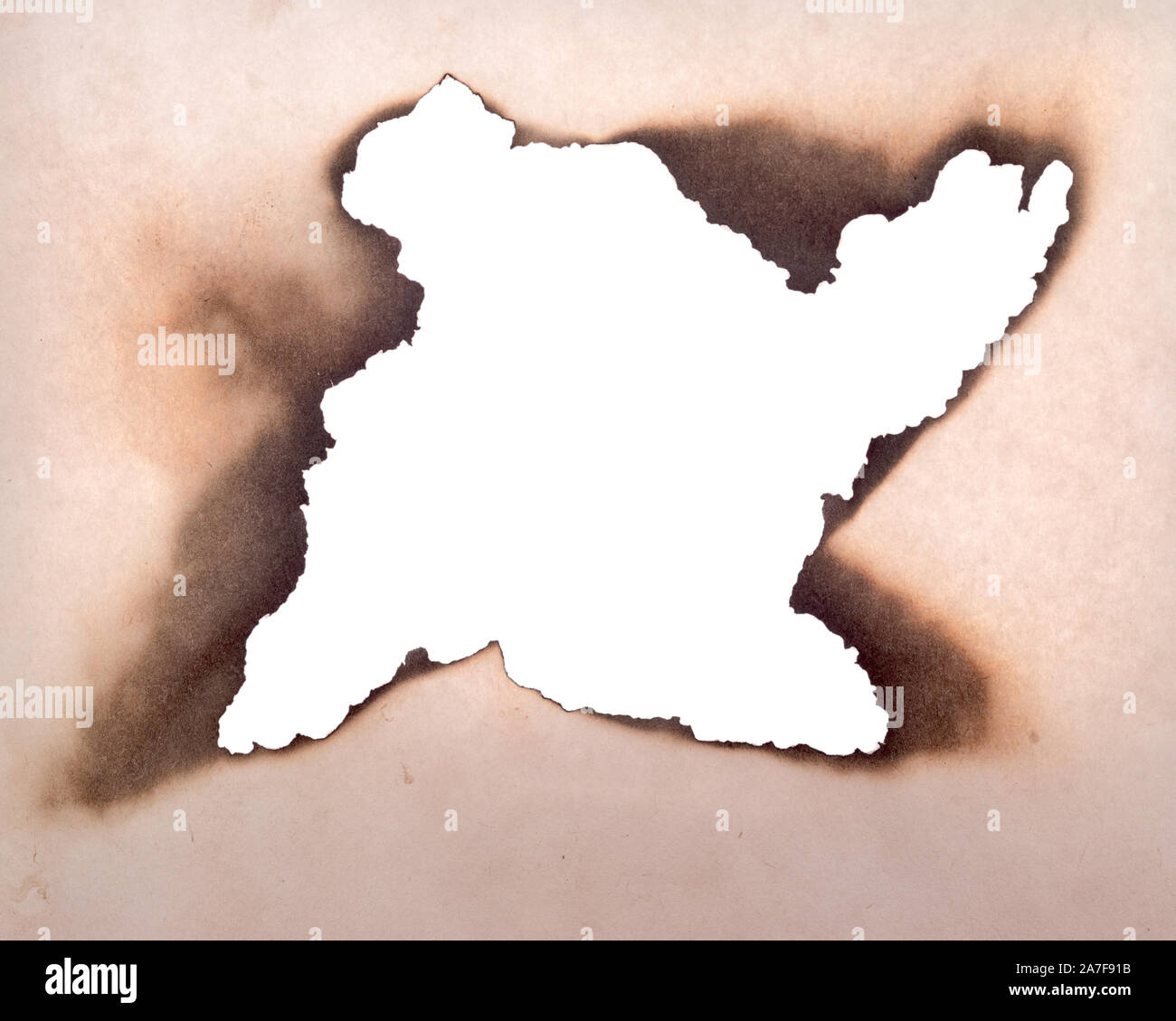 Burnt hole in a paper Stock Photo - Alamy