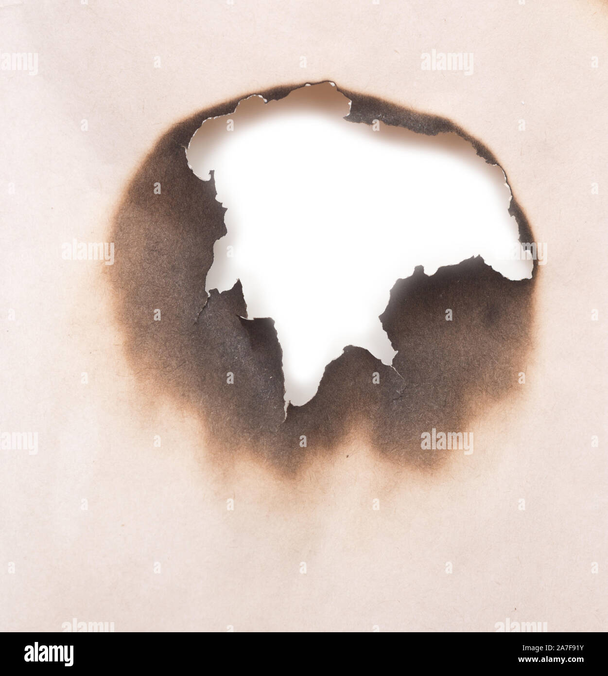 Burnt hole in a paper Stock Photo - Alamy
