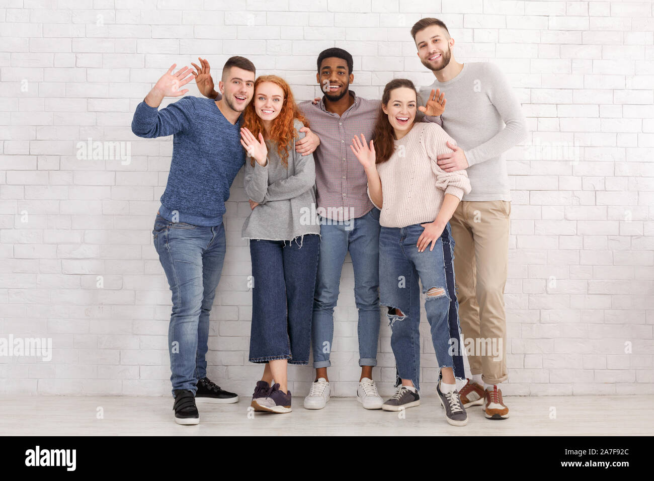 Hi, there! Friends waving hands to camera Stock Photo - Alamy