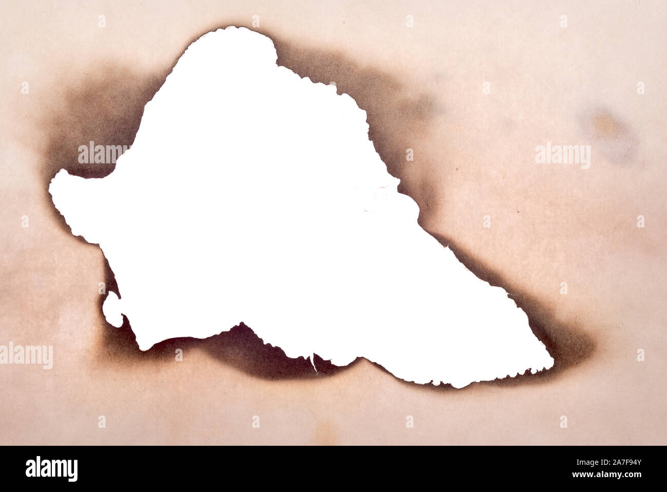 Burnt hole in a paper Stock Photo - Alamy