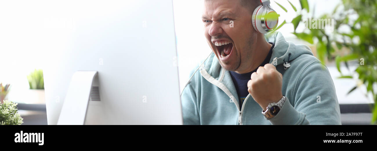 Man screaming in computer monitor sitting Stock Photo - Alamy