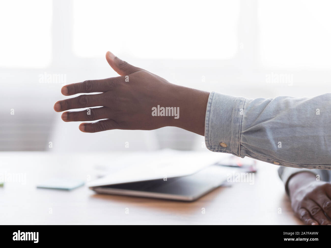 Hand of african american man extended for handshake Stock Photo - Alamy
